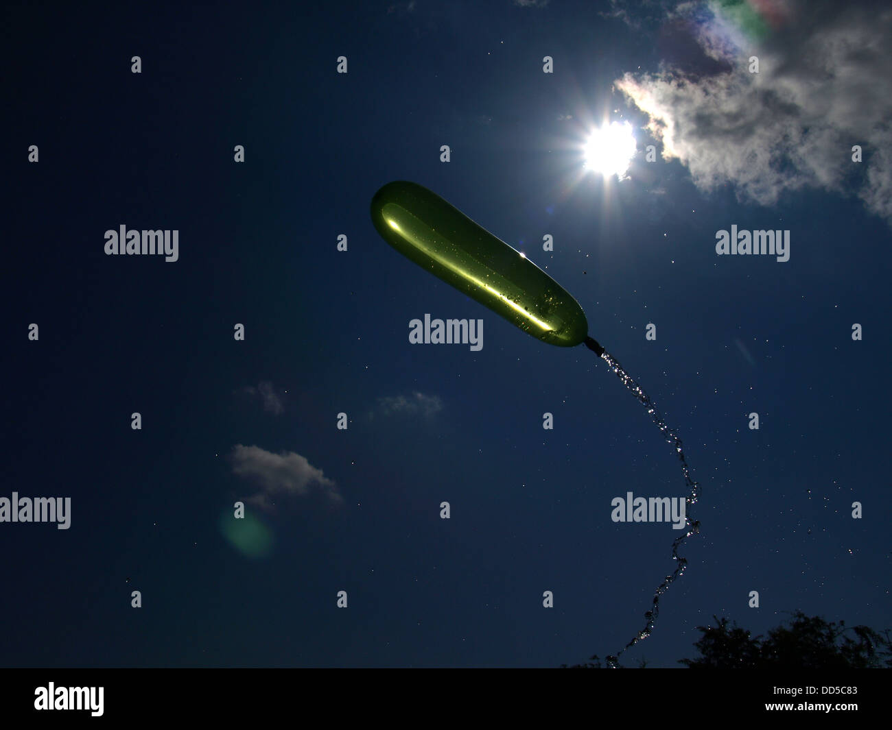 Flying green water balloon Stock Photo - Alamy