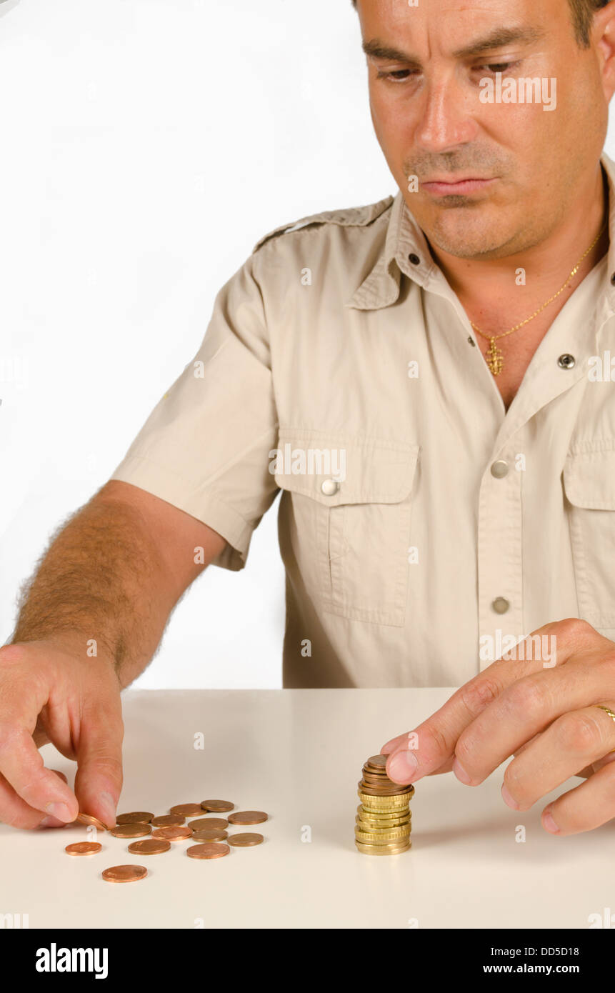 Guy piling up some coins, a personal finance concept Stock Photo - Alamy