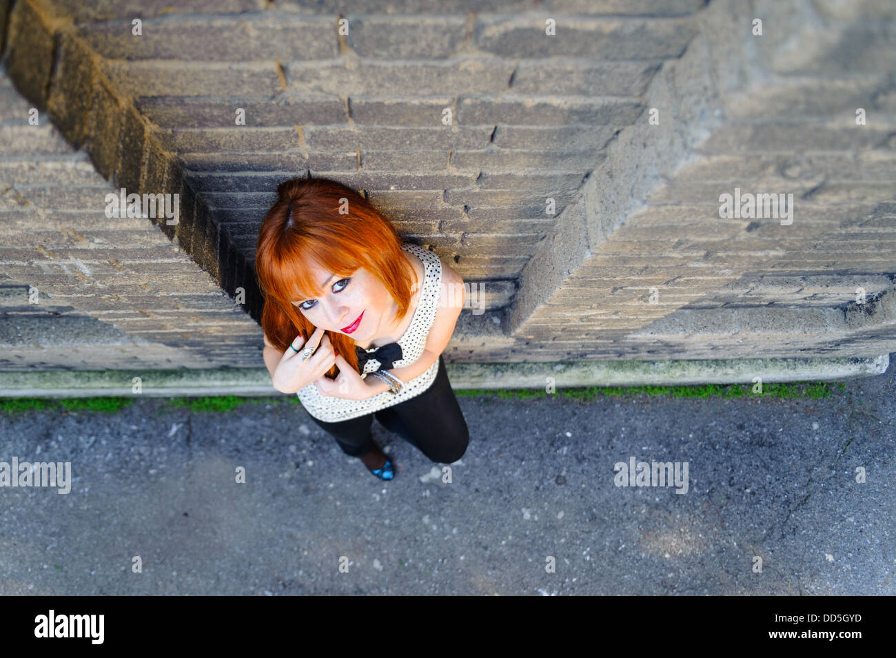 girl standing beside the wall top shot Stock Photo - Alamy