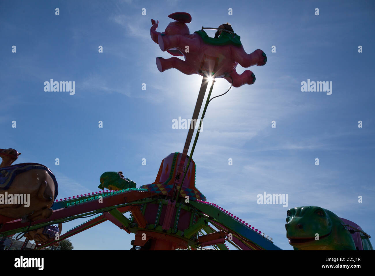 sunburst through flying fantasy animal ride fairground ride Stock Photo ...