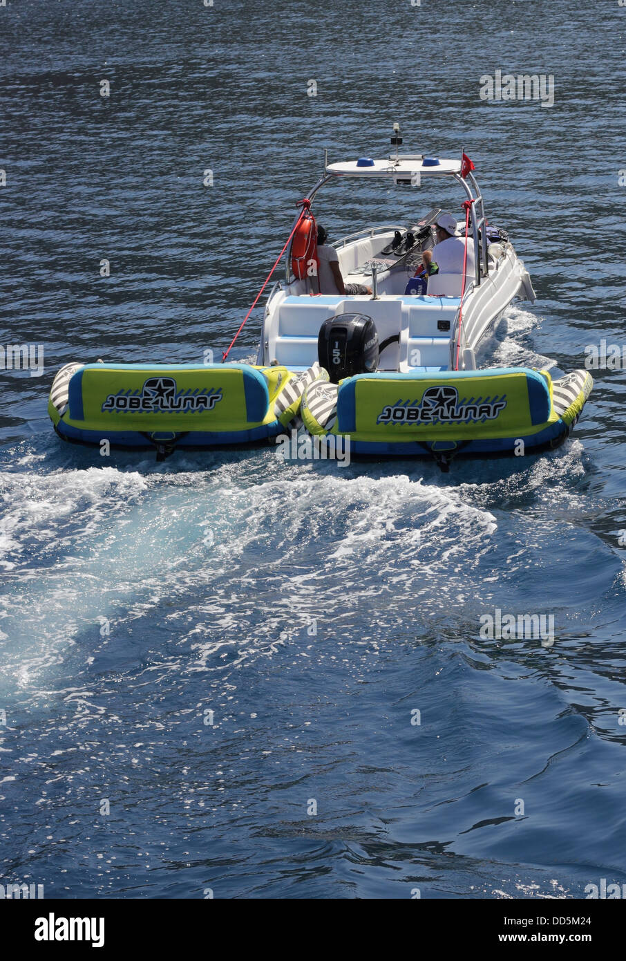 Tourists having fun riding on inflatables Stock Photo - Alamy