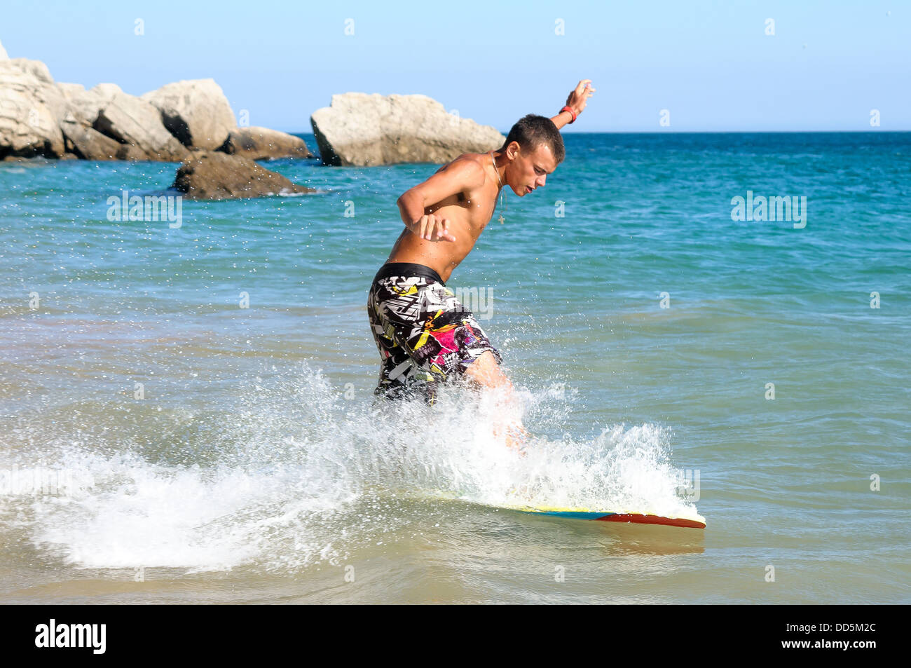 Teenager surfing in the beach Stock Photo - Alamy
