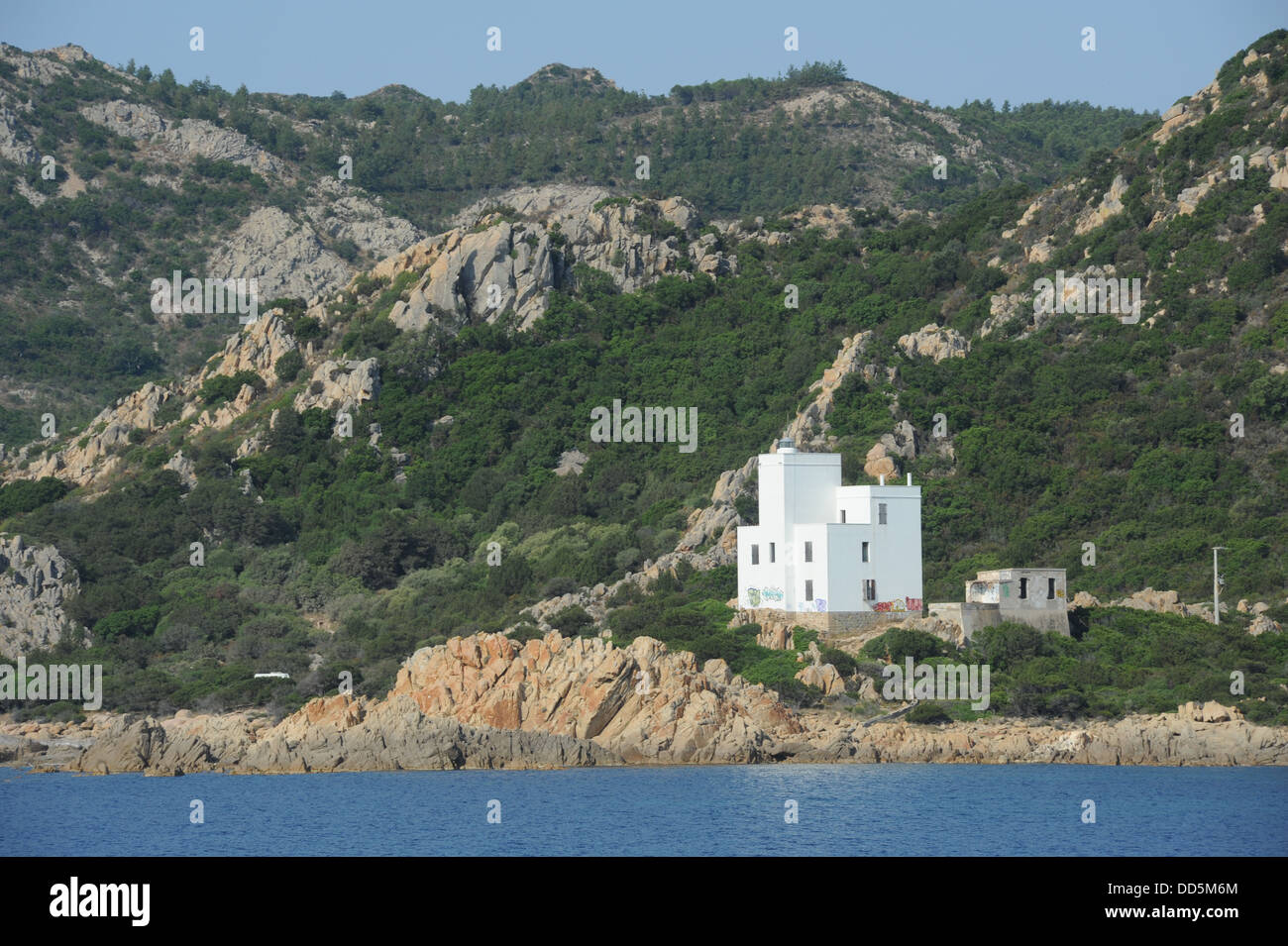 The coast at Capo Comino with the lighthouse on the island of Sardinia ...