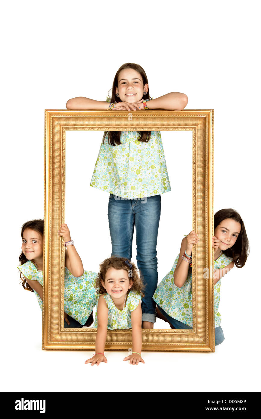 Group of young girls posing with a golden frame Stock Photo - Alamy
