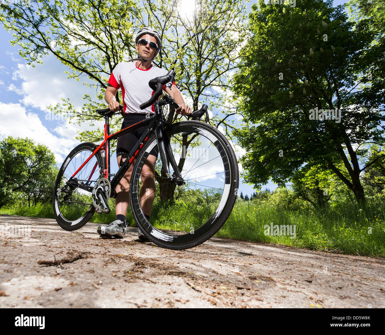 Germany, Mature man standing beside bicycle Stock Photo - Alamy