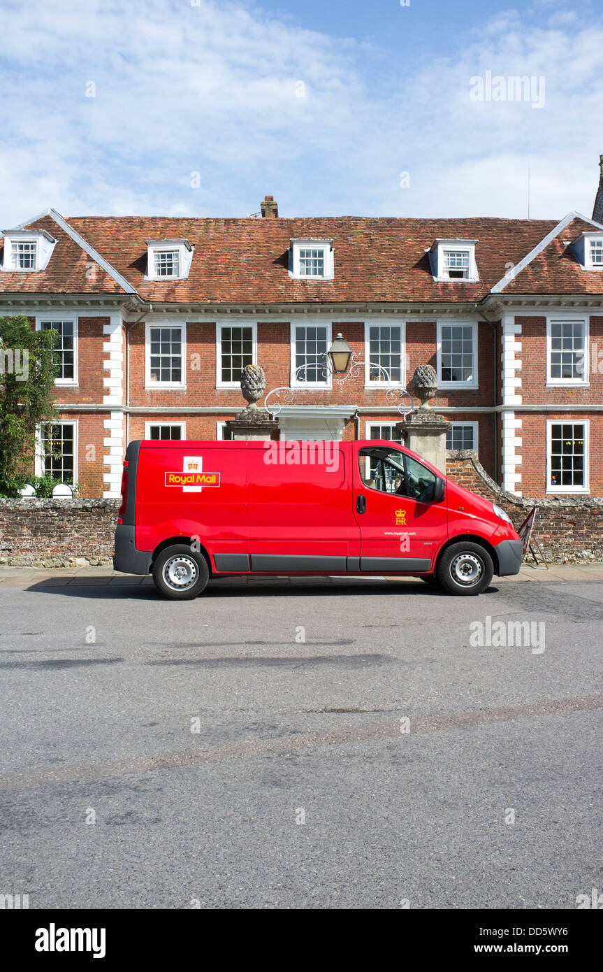 Red UK Royal Mail delivery van parked on street outside large building ...