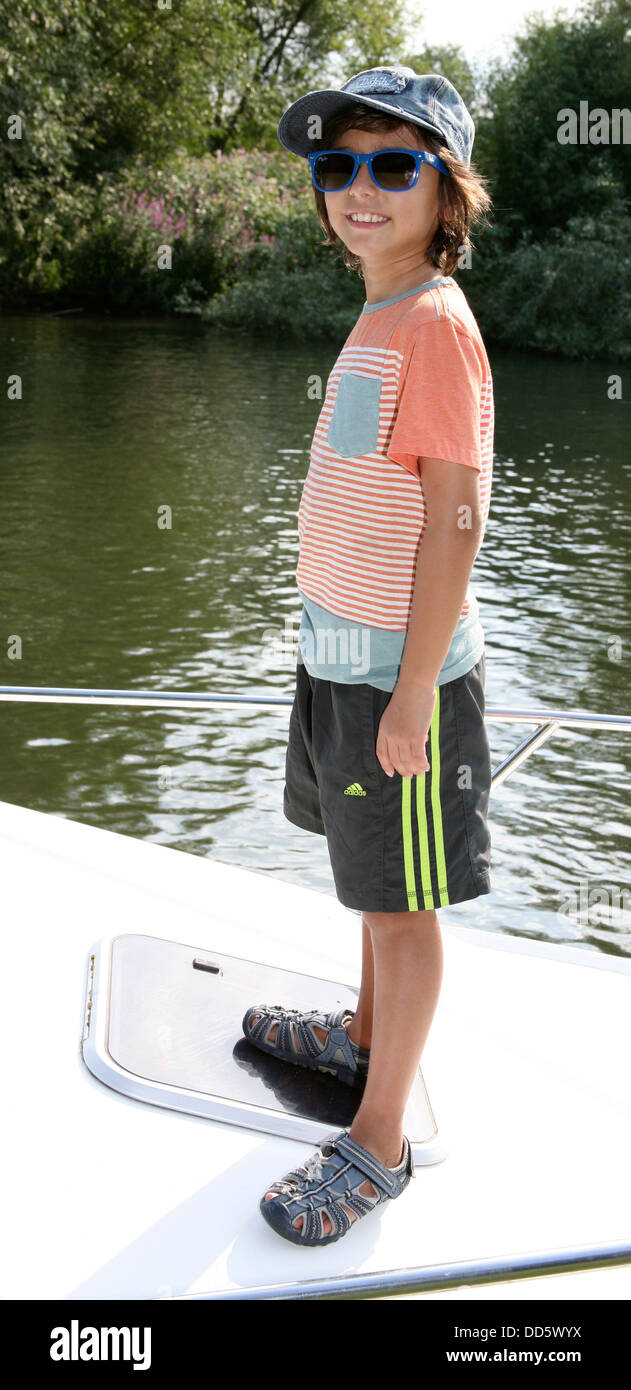 Portrait of smiling boy in sunglasses and baseball cap on boat Stock ...