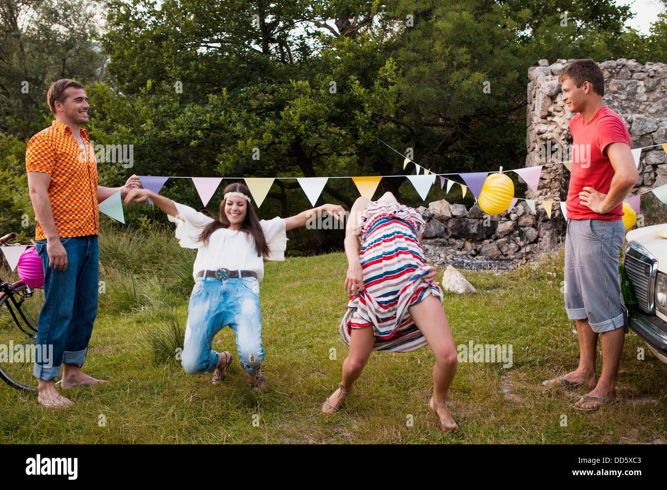 Croatia, Dalmatia, Young women dancing outdoors, men watching Stock ...