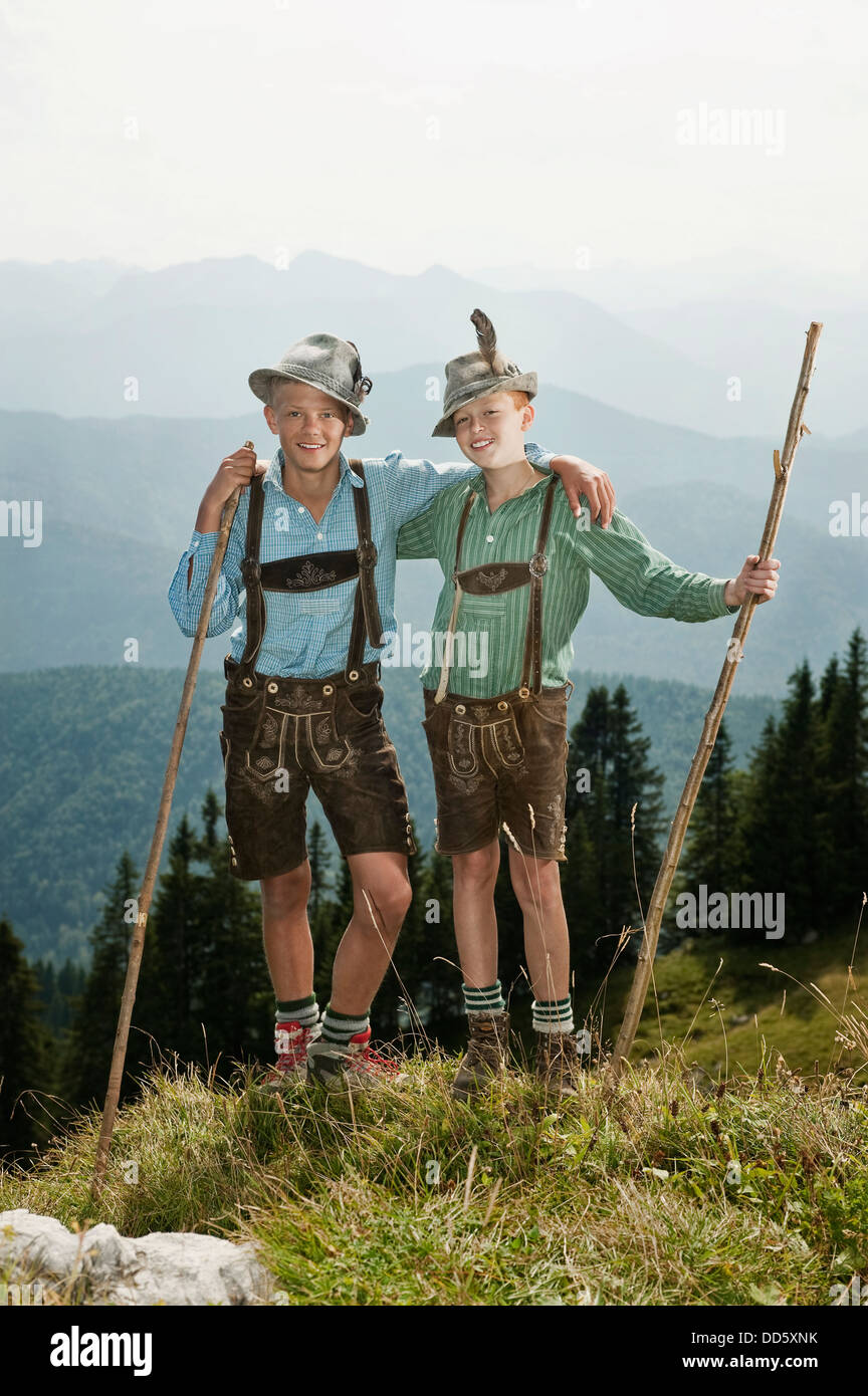 Germany, Bavaria, Two boys in traditional clothing standing arm in arm ...