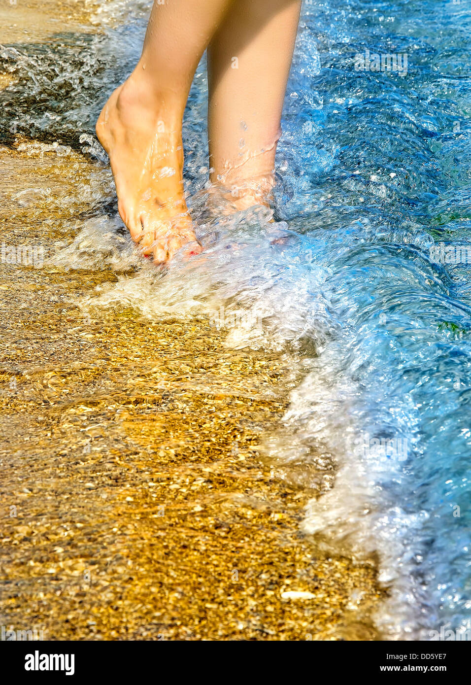 Feet washed in surf on sandy beach Stock Photo - Alamy