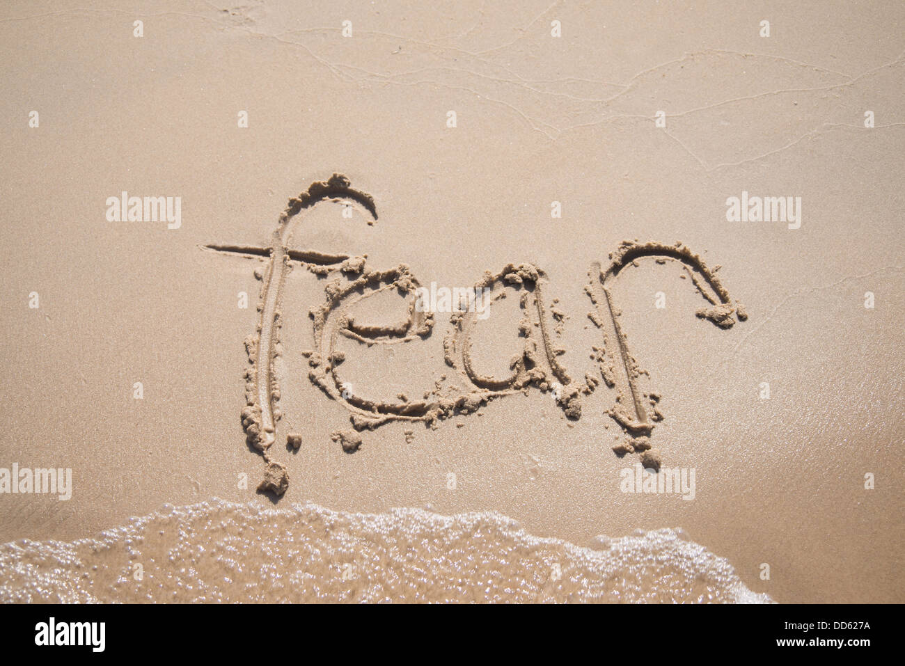 The word "fear" written in the sand Stock Photo - Alamy