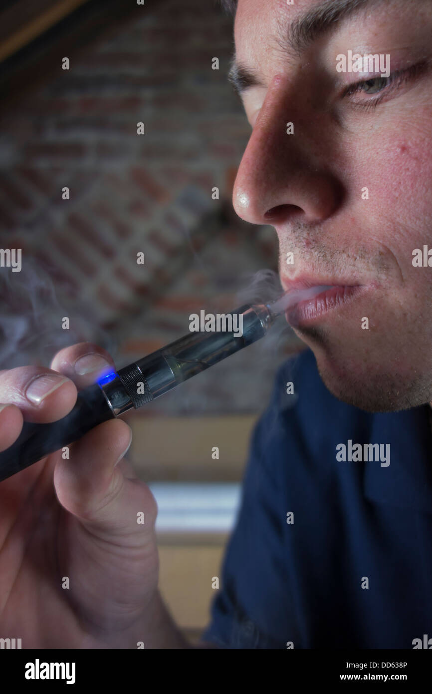 Male breathing in the vapor from an electronic cigarette Stock Photo ...