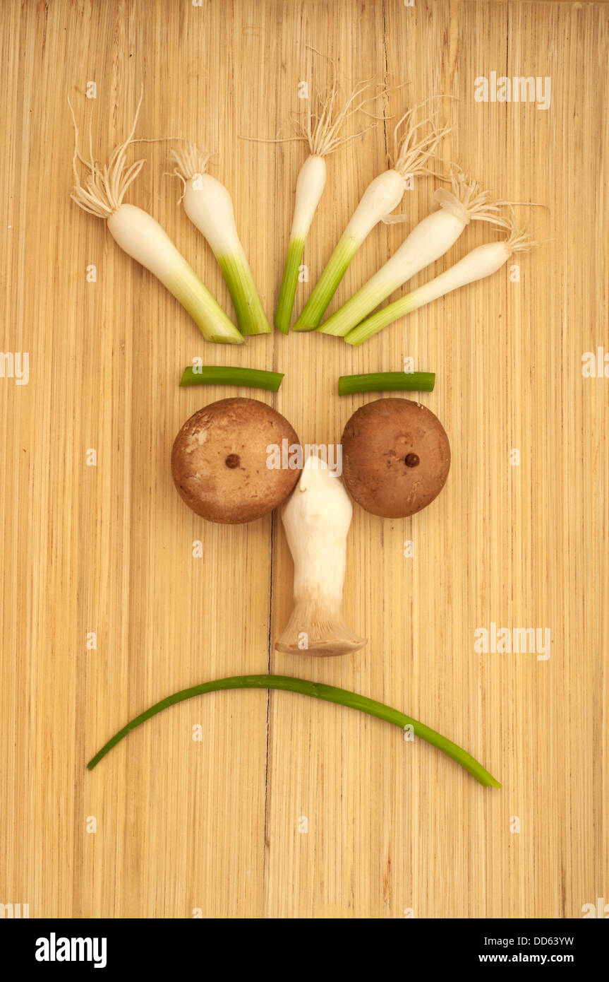 Sad vegetable face with mushrooms, spring onions and pepper Stock Photo ...