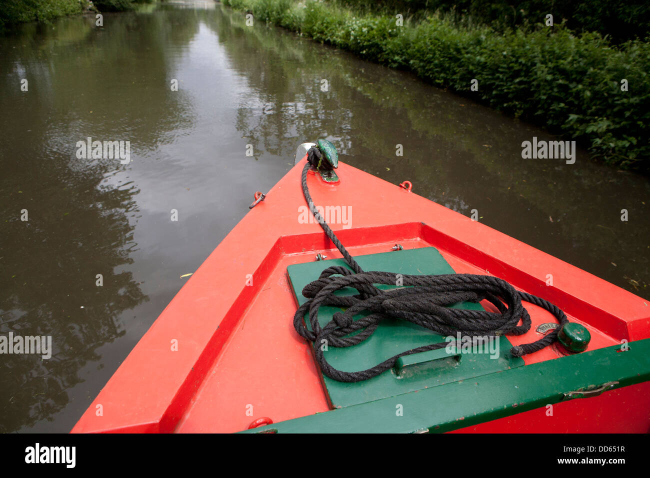 The bow of a red and green narrow boat cruising on a canal Stock Photo ...
