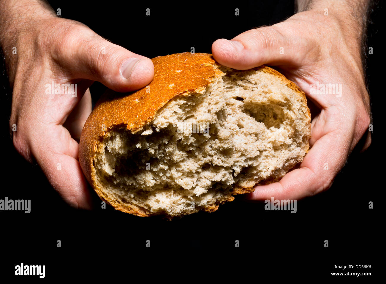 Mature man holding bread, close up Stock Photo - Alamy