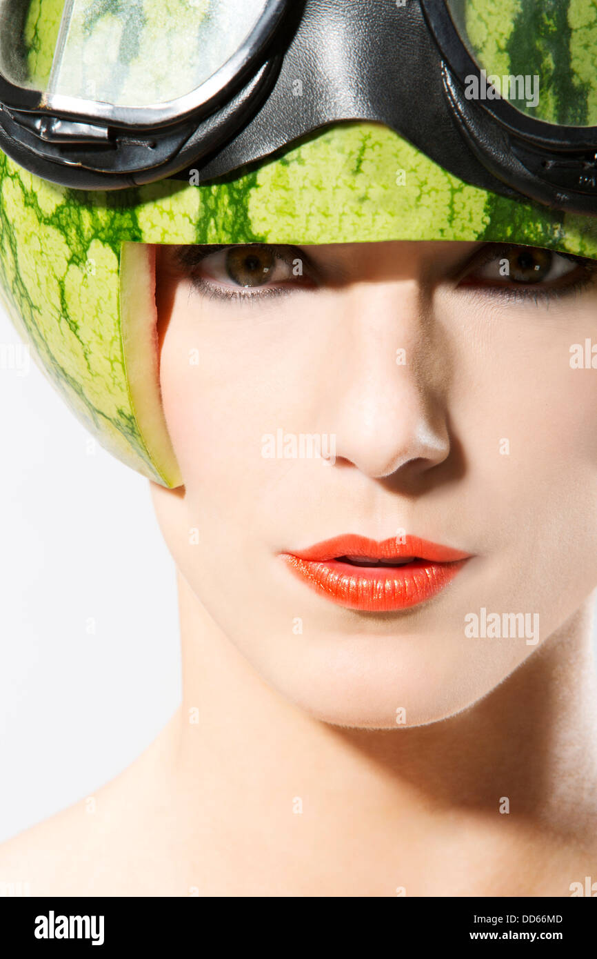 Portrait of young woman wearing watermelon helmet, close up Stock Photo ...