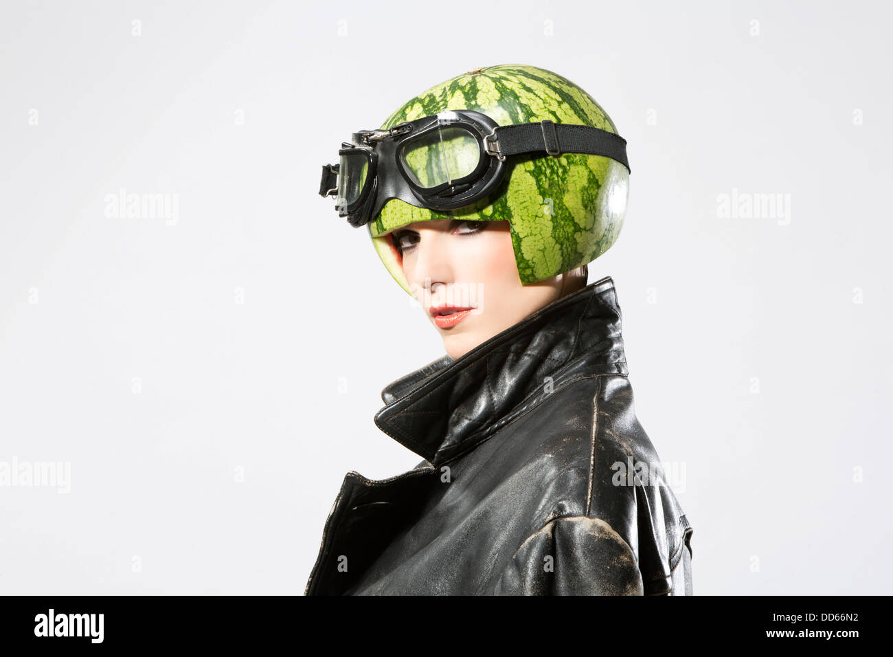 Portrait of young woman wearing watermelon helmet, close up Stock Photo ...