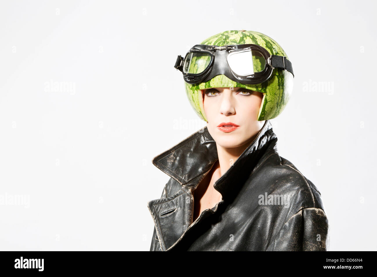 Portrait of young woman wearing watermelon helmet, close up Stock Photo ...