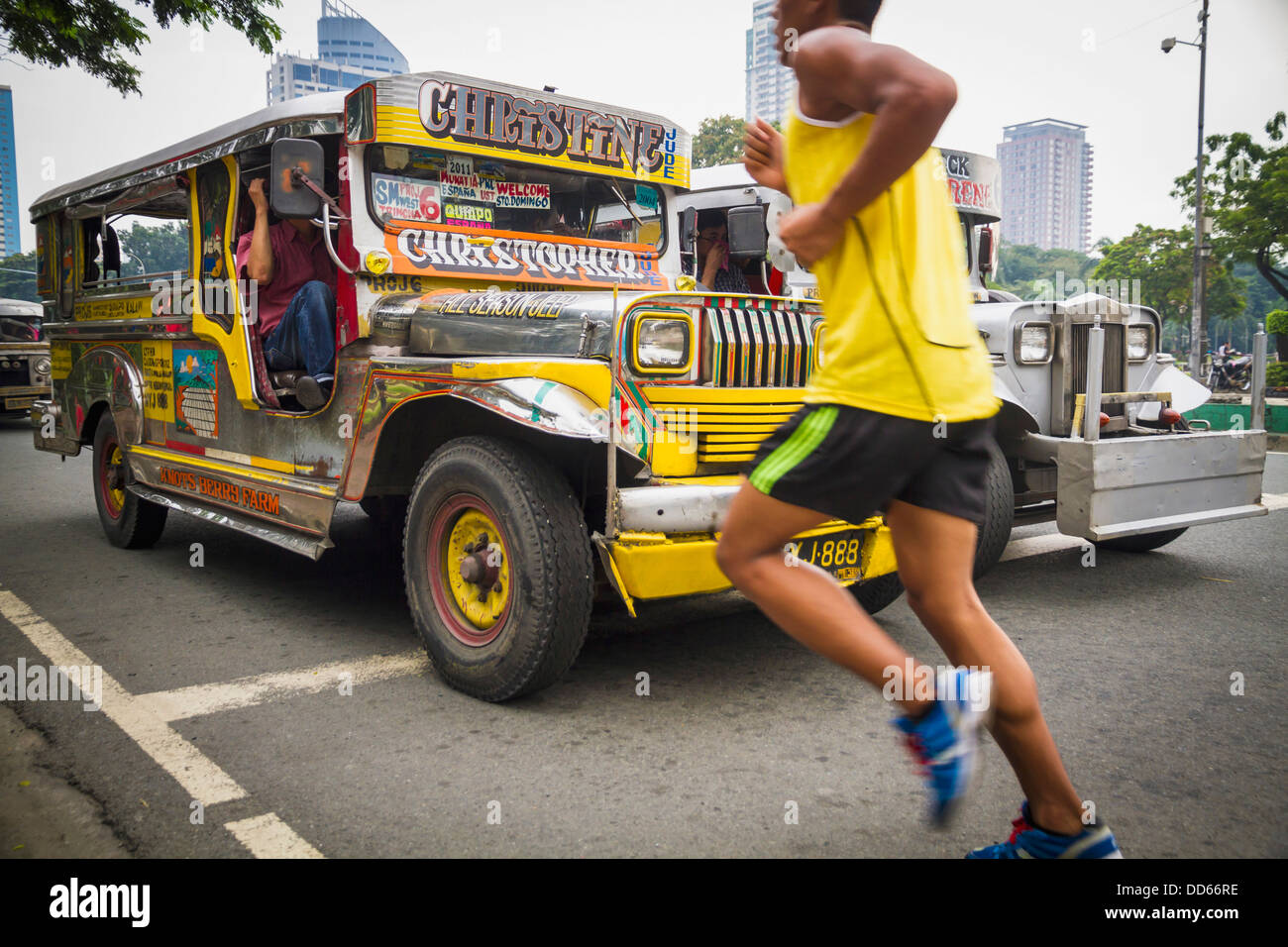 Philippines, Manila, Jogger in front of jeepneys Stock Photo - Alamy