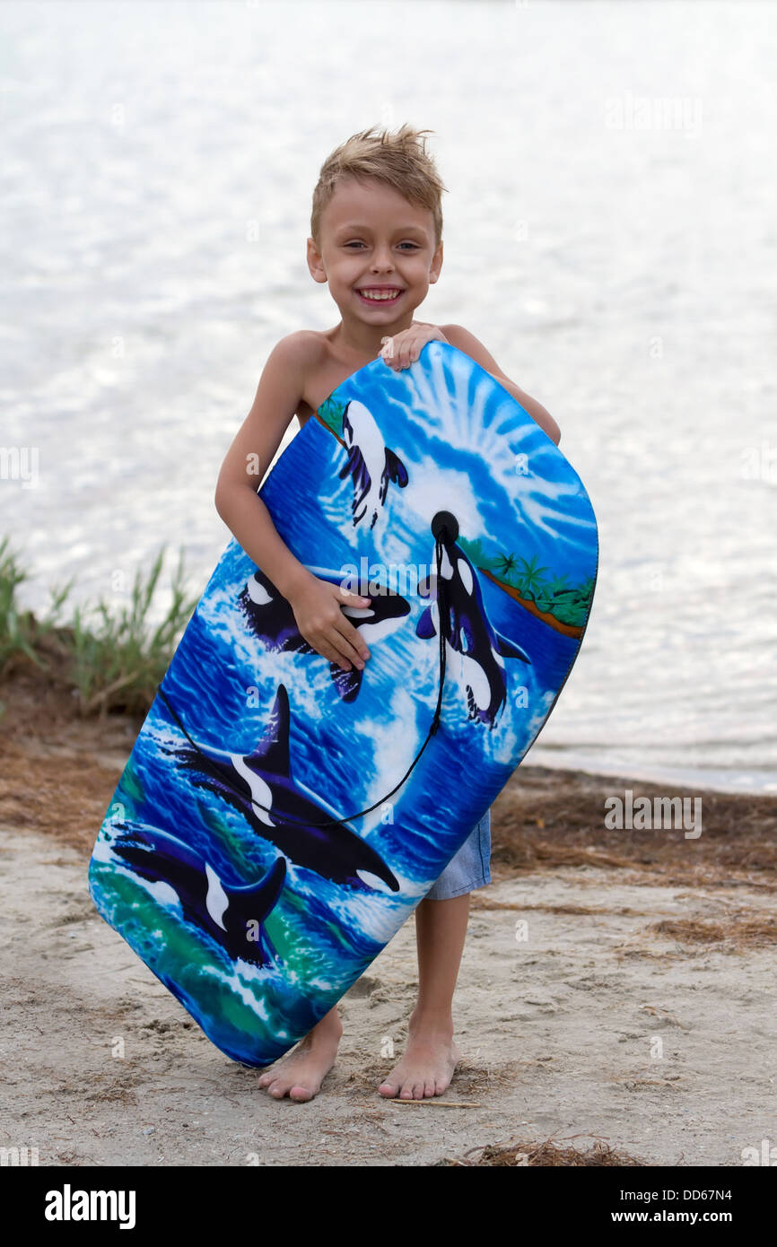 Funny little boy with blue surfing board on the beach Stock Photo - Alamy