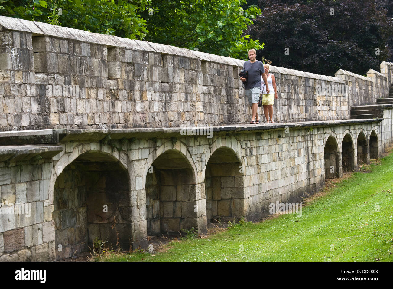Tourists walk a section of the city walls around York North Yorkshire ...