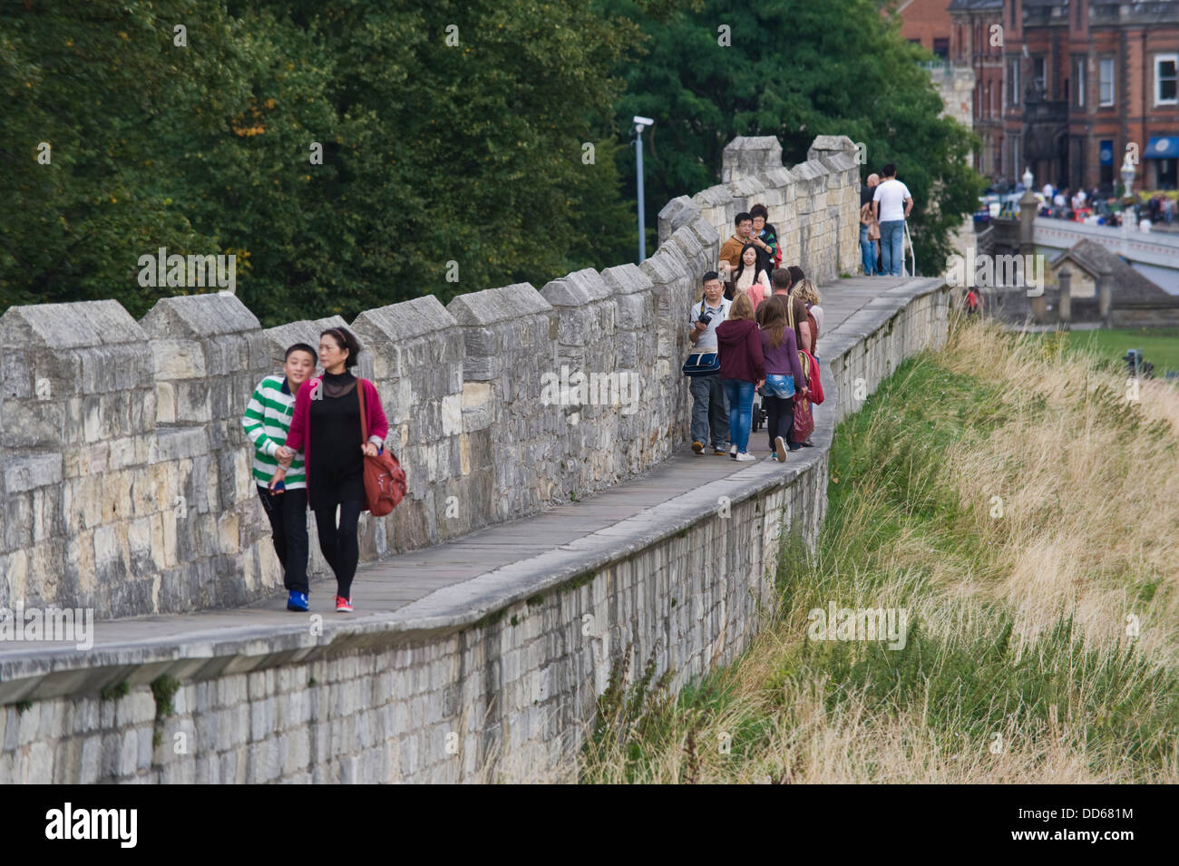 Tourists walk a section of the city walls around York North Yorkshire ...
