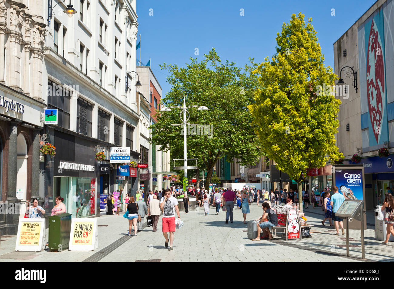 Cardiff city centre people walking up Queen Street Cardiff city centre ...