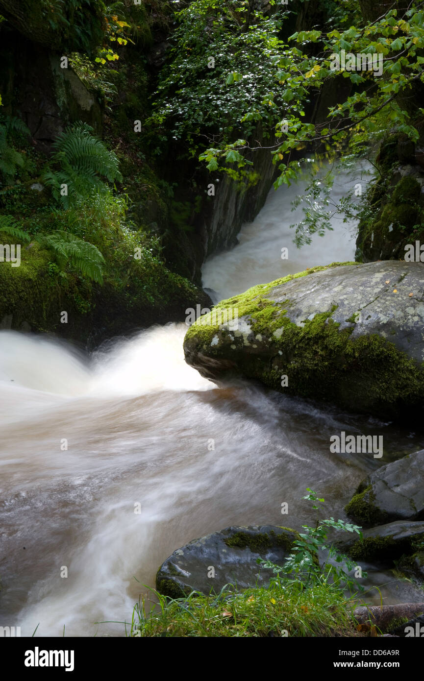 Fast flowing water running down a stream towards a waterfall in the ...