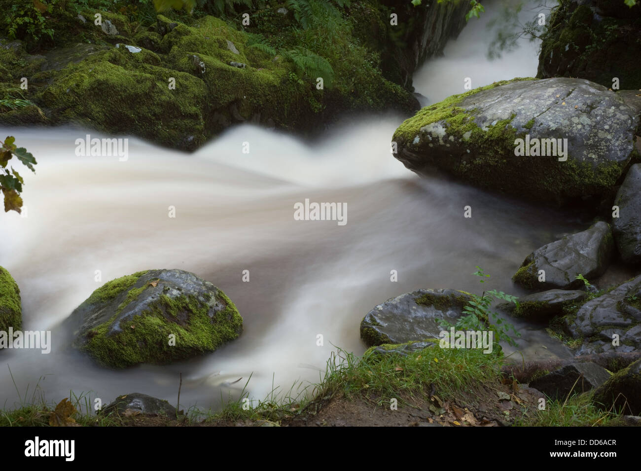 Fast flowing water running down a stream towards a waterfall in the ...