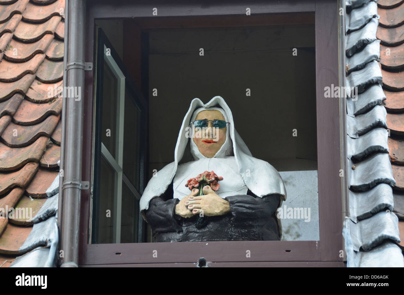 Humorous statue of nun, Bruges window, Belgium Stock Photo - Alamy