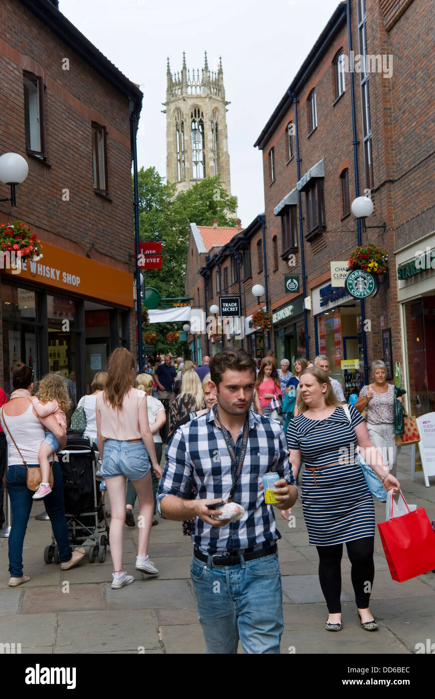 Tourists and shoppers stroll around Coppergate Walk in city centre of ...