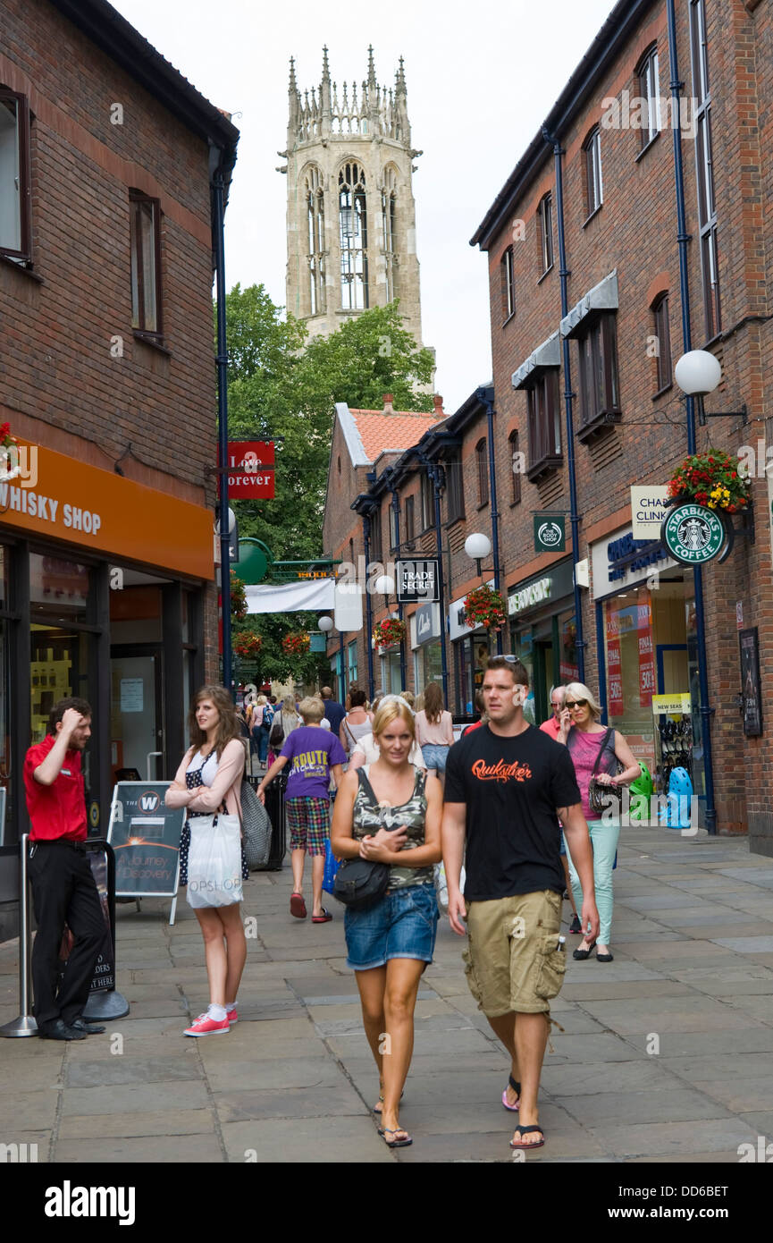 Tourists and shoppers stroll around Coppergate Walk in city centre of ...