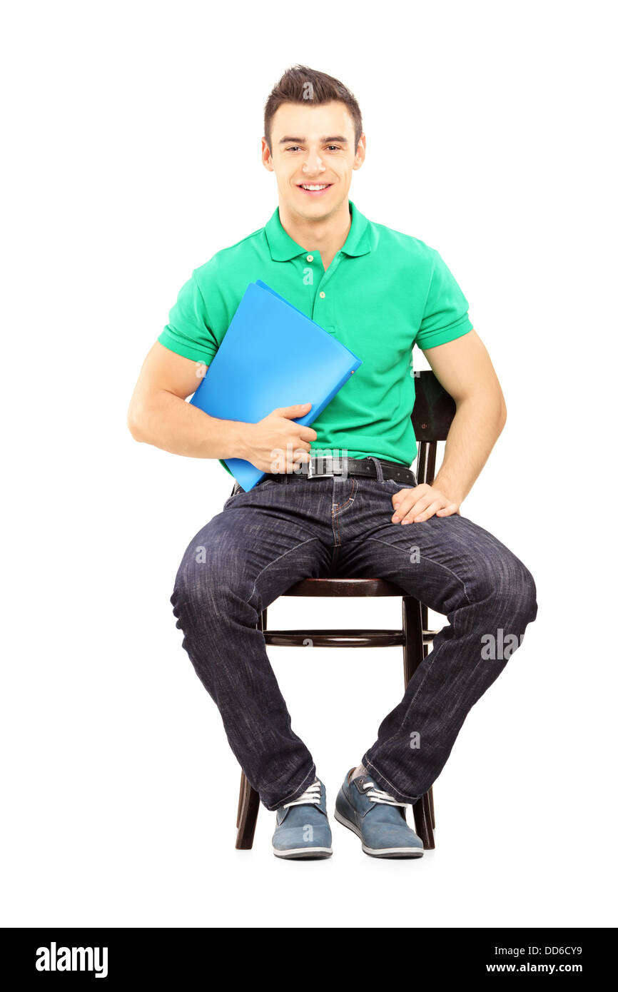 Young handsome male sitting on a chair waiting for job interview ...