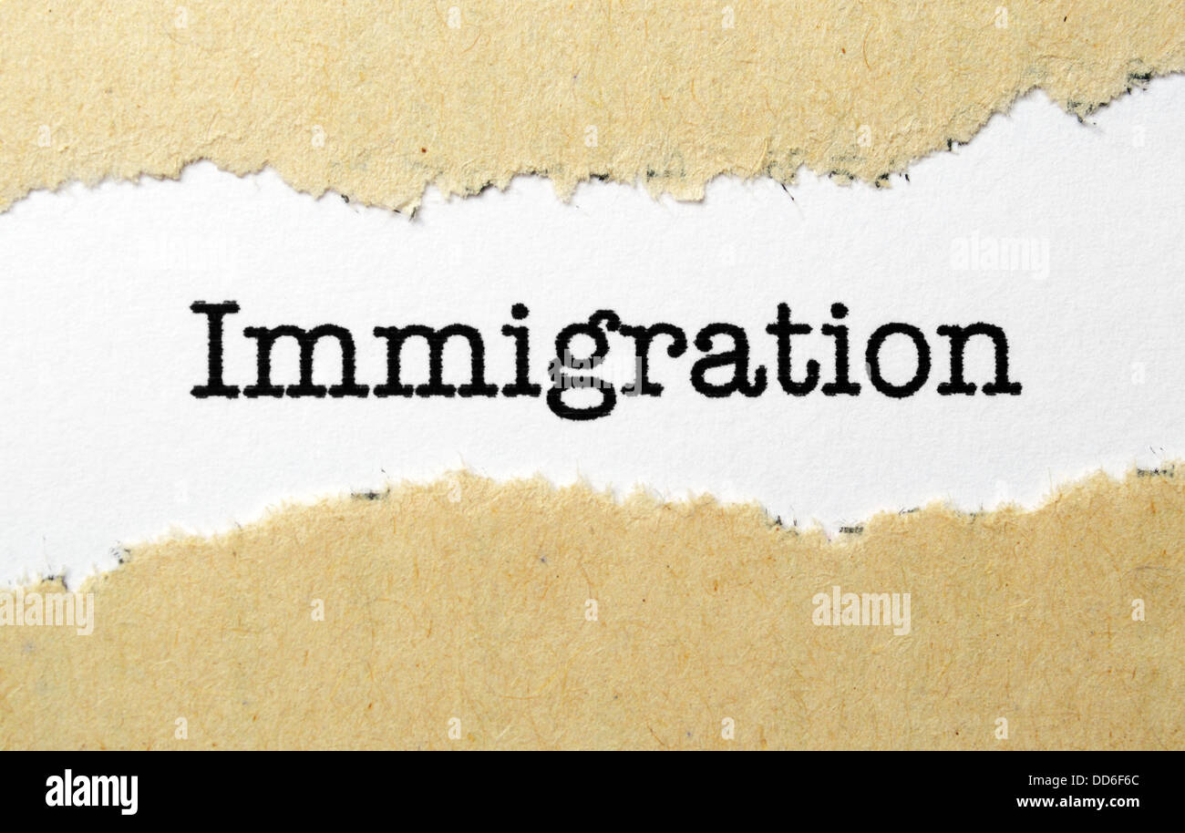 Immigration text on paper hole Stock Photo - Alamy
