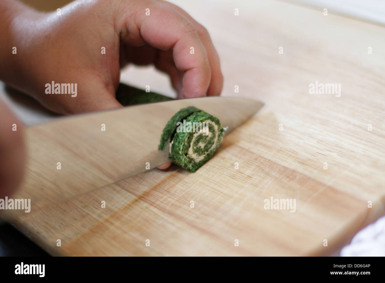 Cutting Spinach Roll Stock Photo - Alamy
