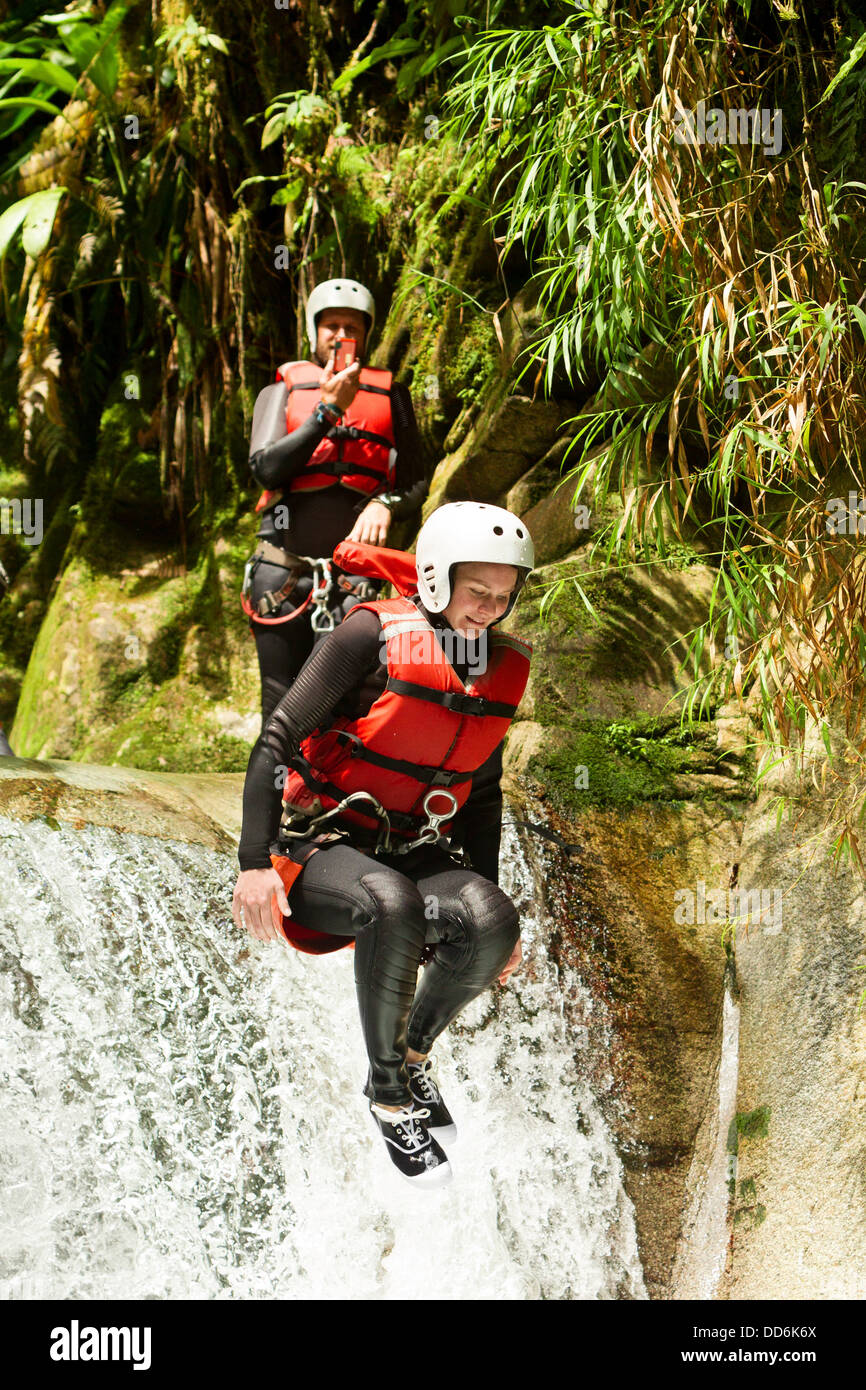 Young Woman Jump Into A Waterfall While Being Photographed Stock Photo ...