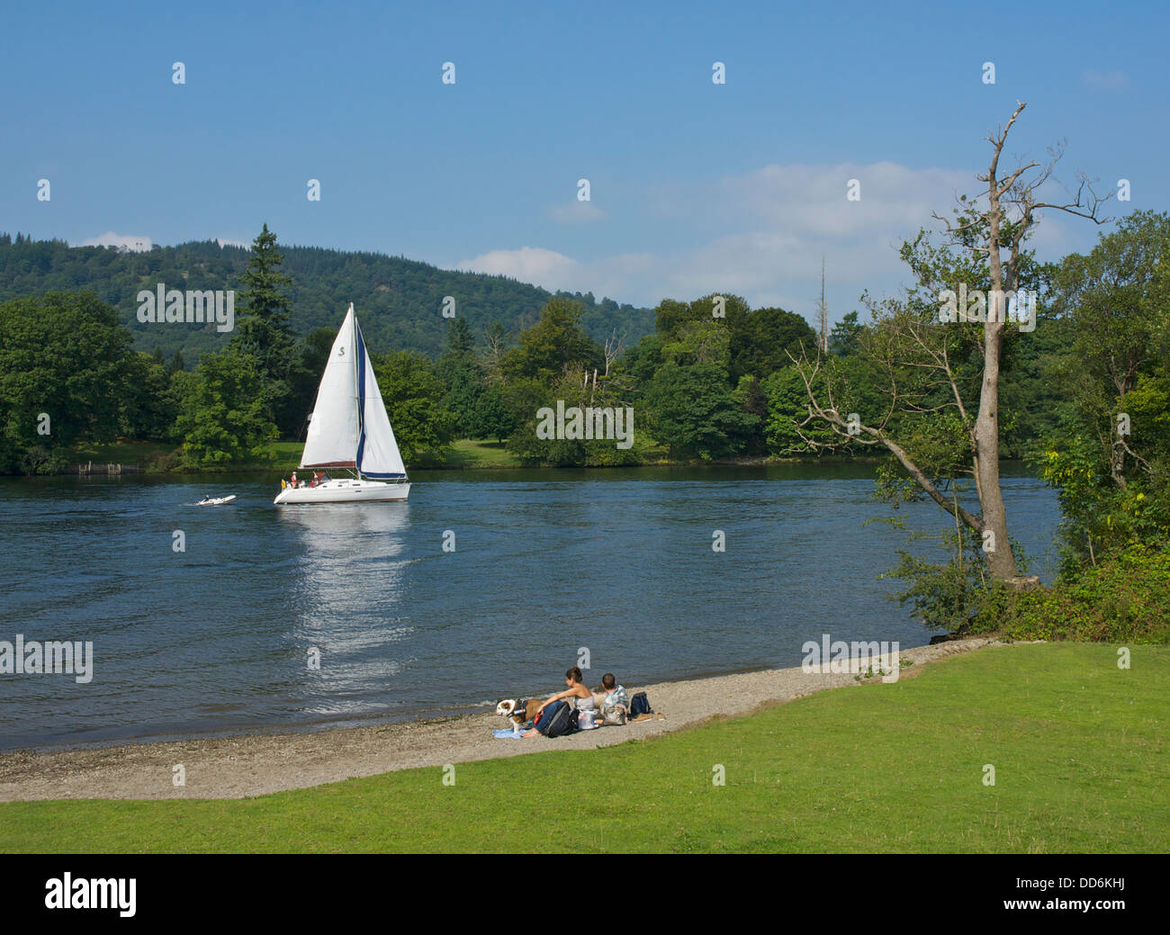 Young couple relaxing on beach, Cockshott Point, Lake Windermere ...