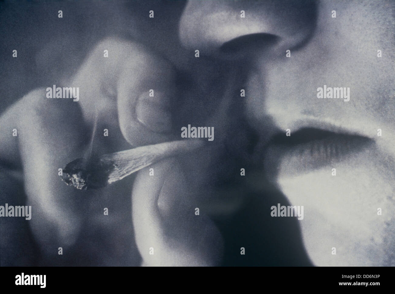 Closeup of person smoking weed joint marijuana cigarette roach pot ...