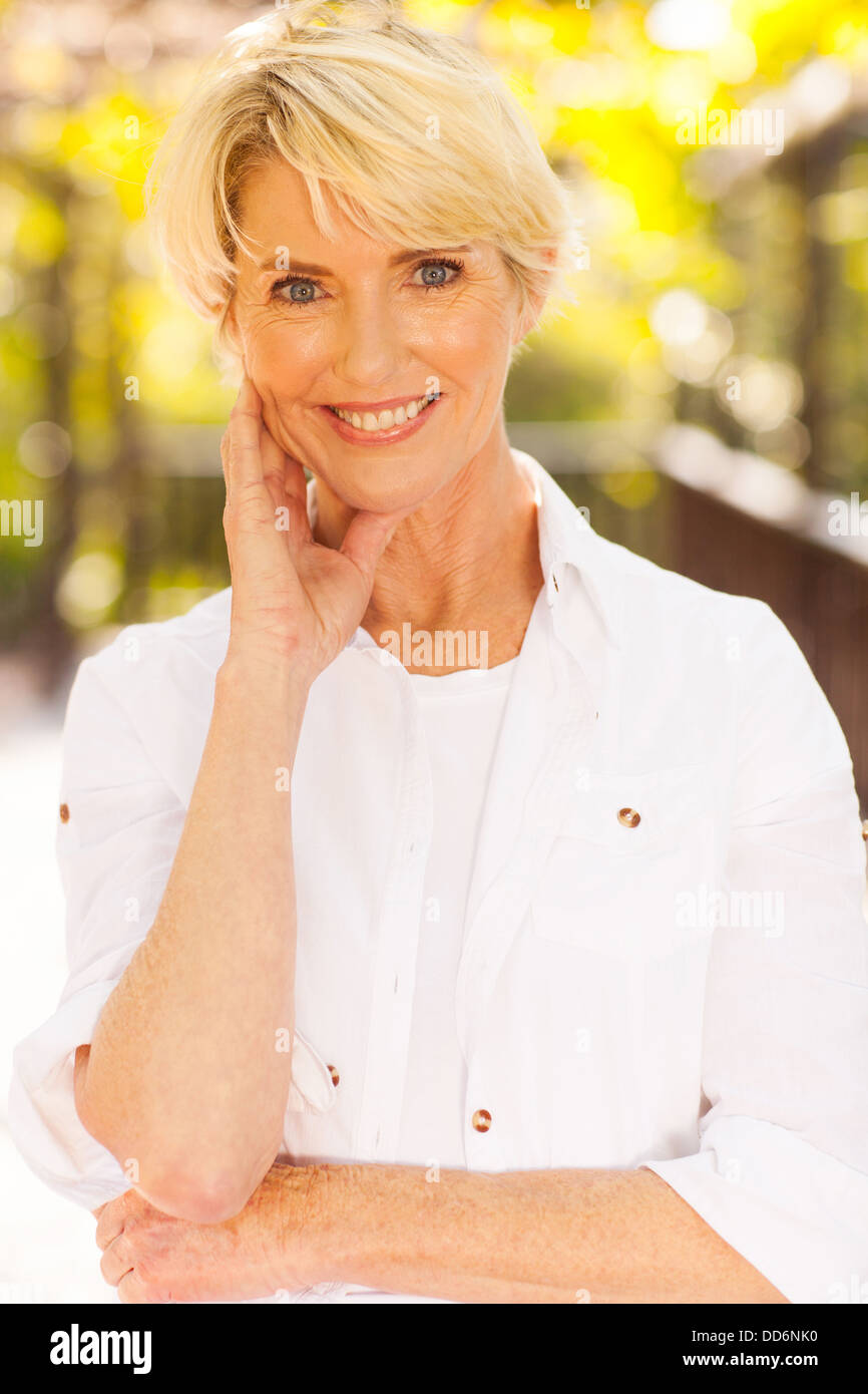 attractive elegant mid age woman standing outdoors Stock Photo - Alamy