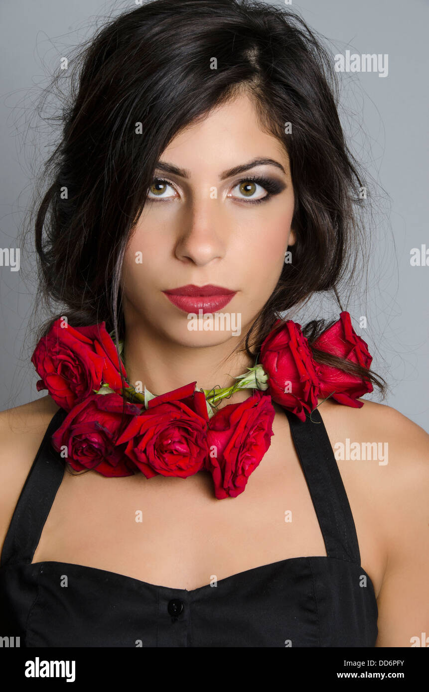 A beauty photograph of young woman/model adorned with red roses Stock ...