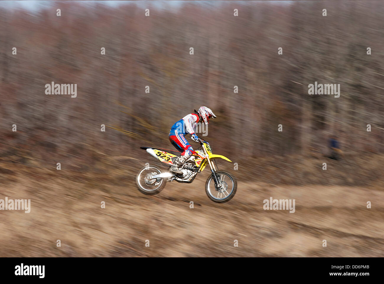 Motorcycle/motorbike riders race through the track/the pit at a ...