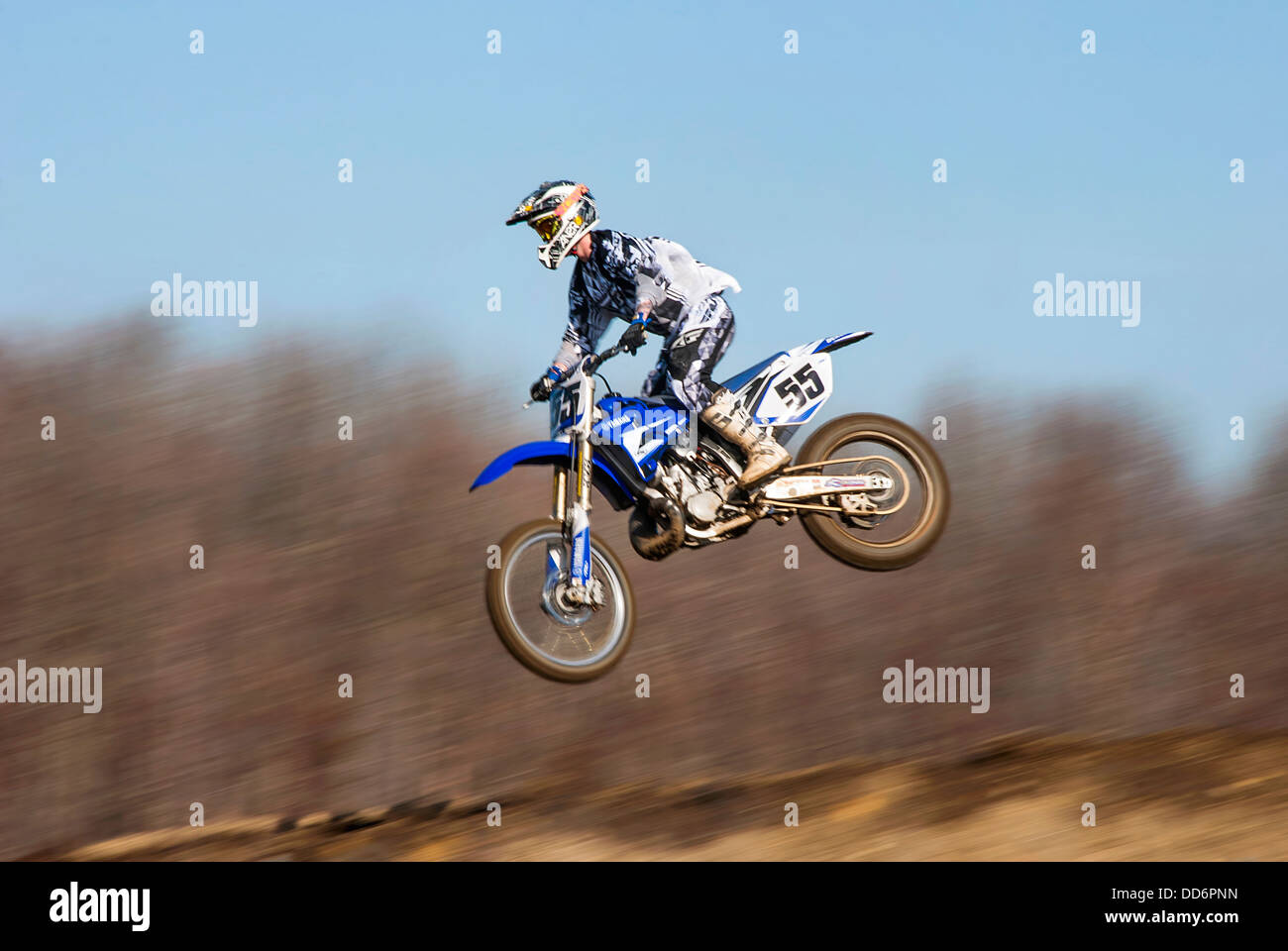 Motorcycle/motorbike riders race through the track/the pit at a ...