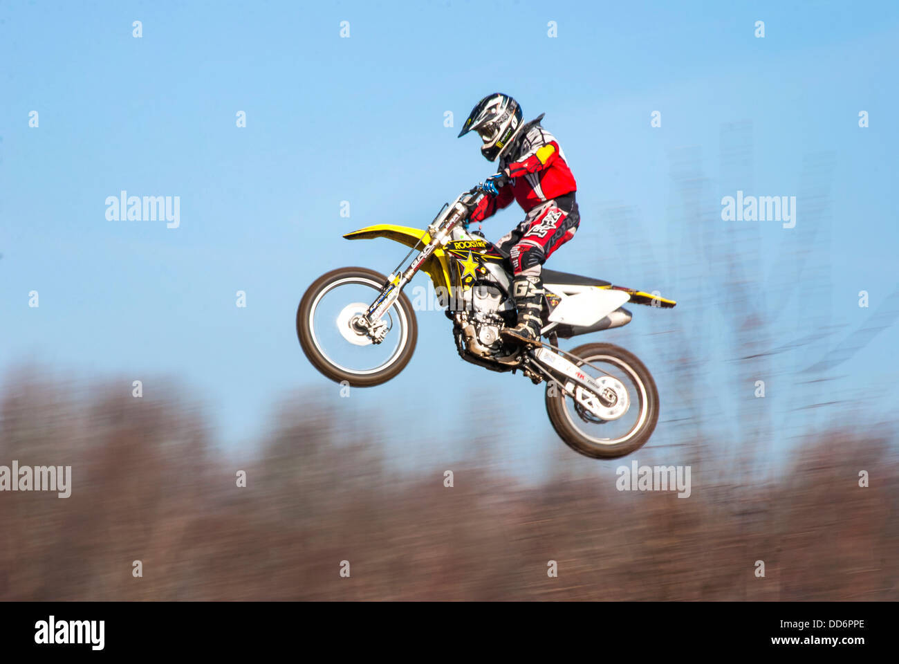 Motorcycle/motorbike riders race through the track/the pit at a ...
