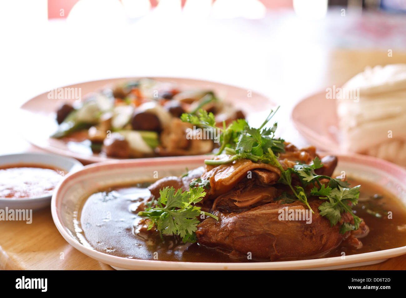 Pork leg stew in plate eat with mantou Stock Photo - Alamy