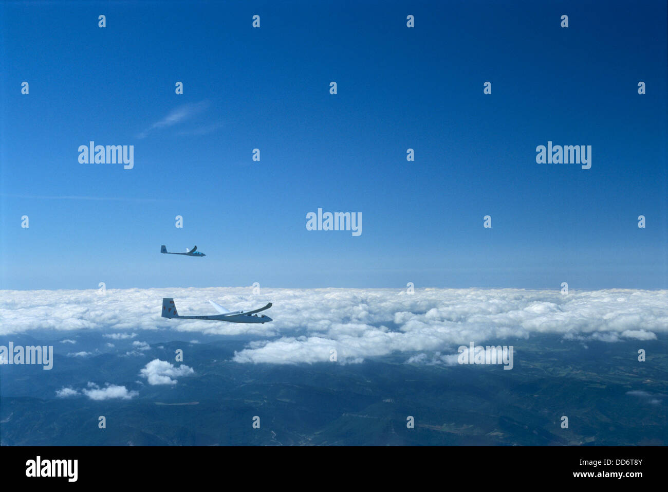 Two glider planes Duo Discus flying over clouds in wave flight near ...