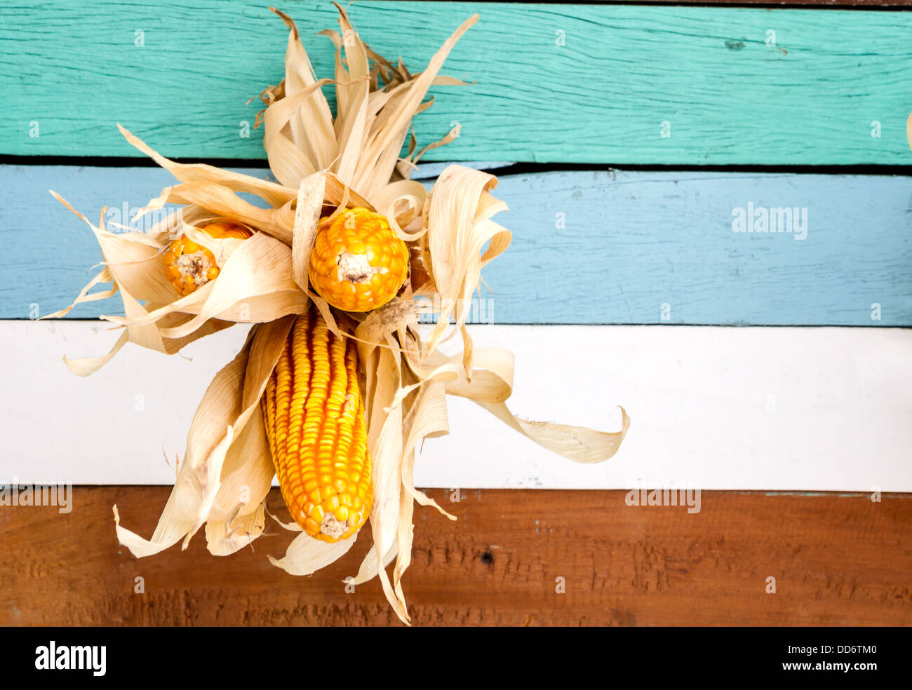 Corn with wood background Stock Photo - Alamy