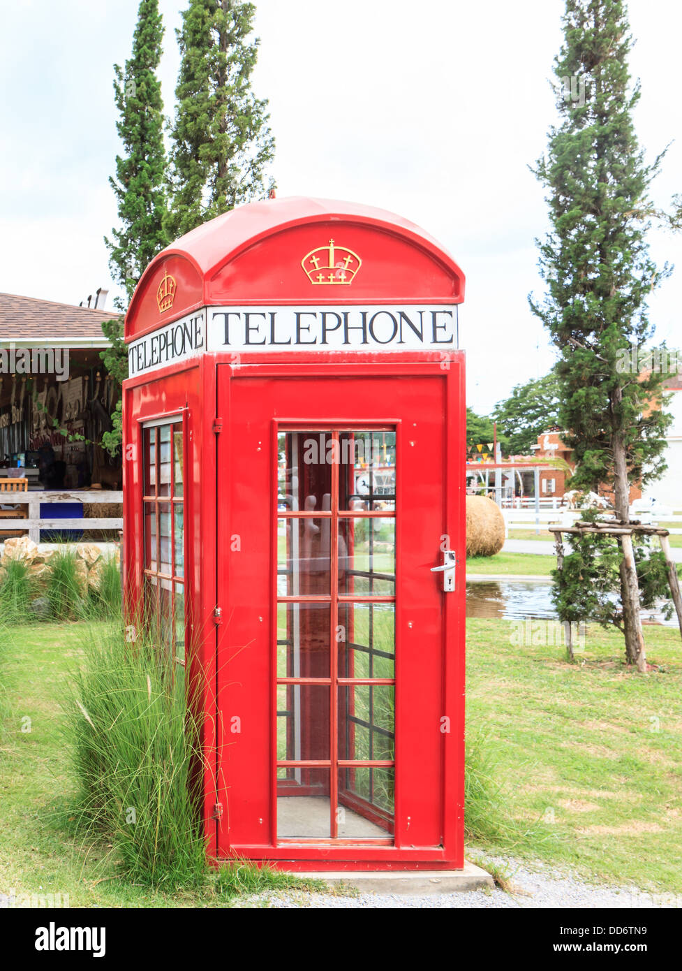 Single red phone box on field Stock Photo - Alamy