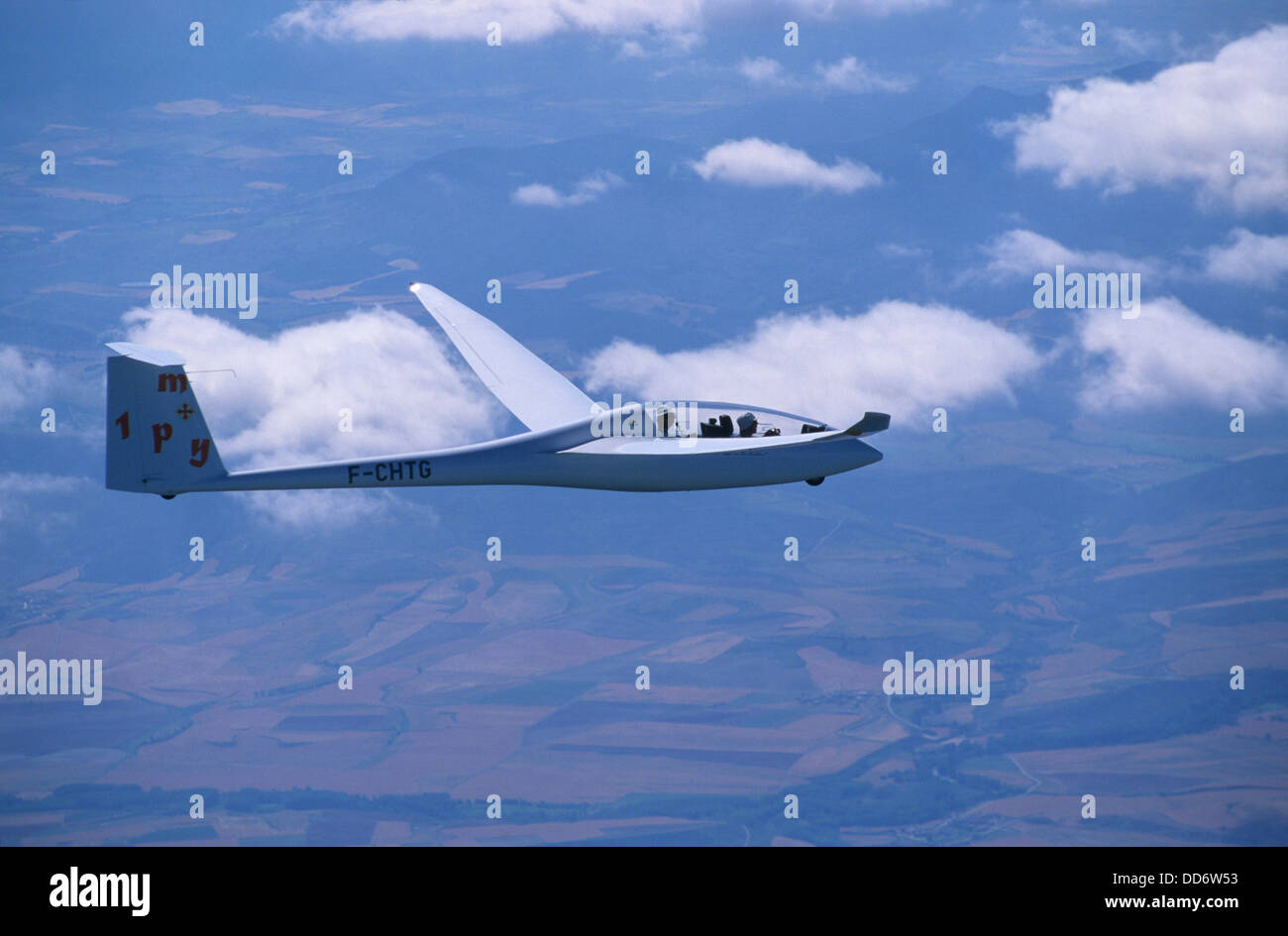 Glider plane Duo Discus flying over clouds in wave flight near Jaca ...