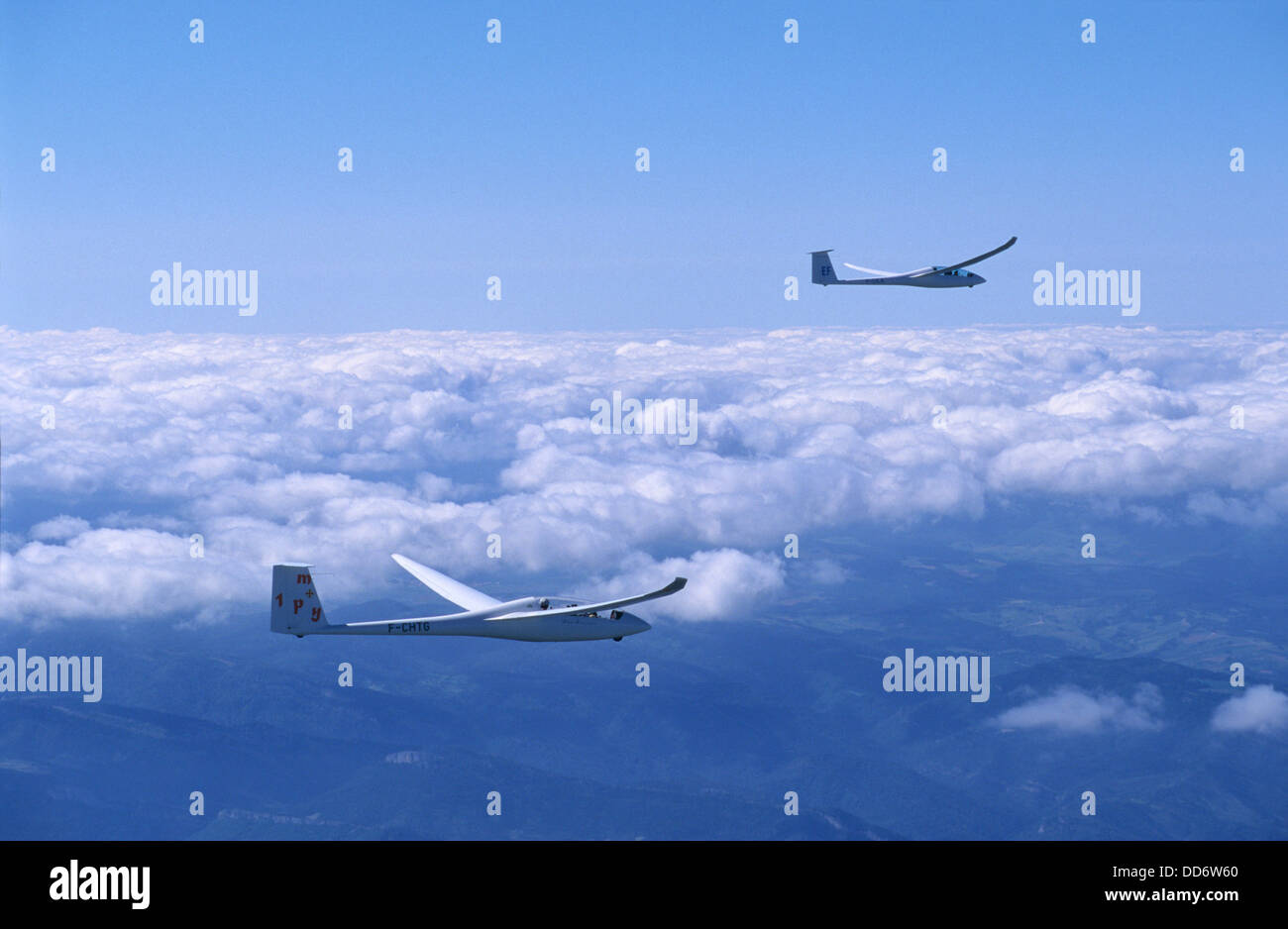 Two glider planes Duo Discus flying over clouds in wave flight near ...