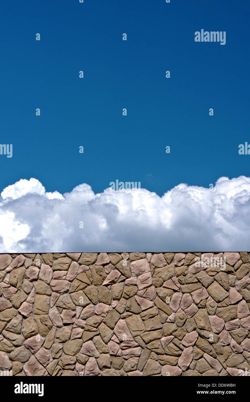 Stone wall and blue sky with clouds Stock Photo - Alamy